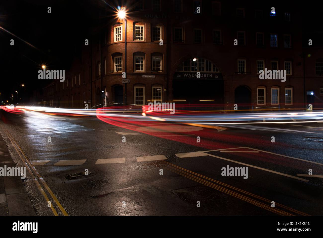A night street view with light trails outside Wadworth Brewery in ...