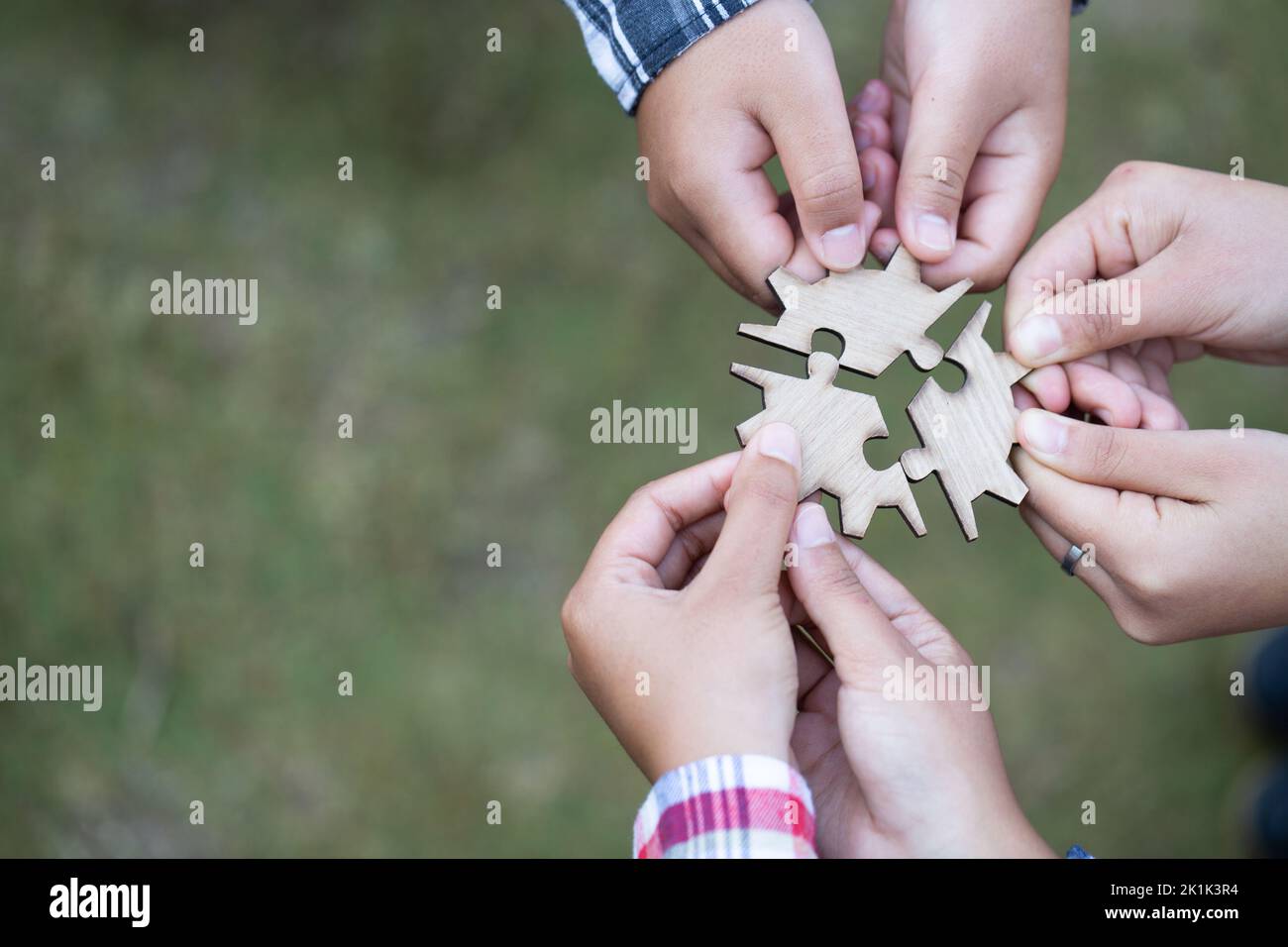 people helping in assembling puzzle, cooperation in decision making ...
