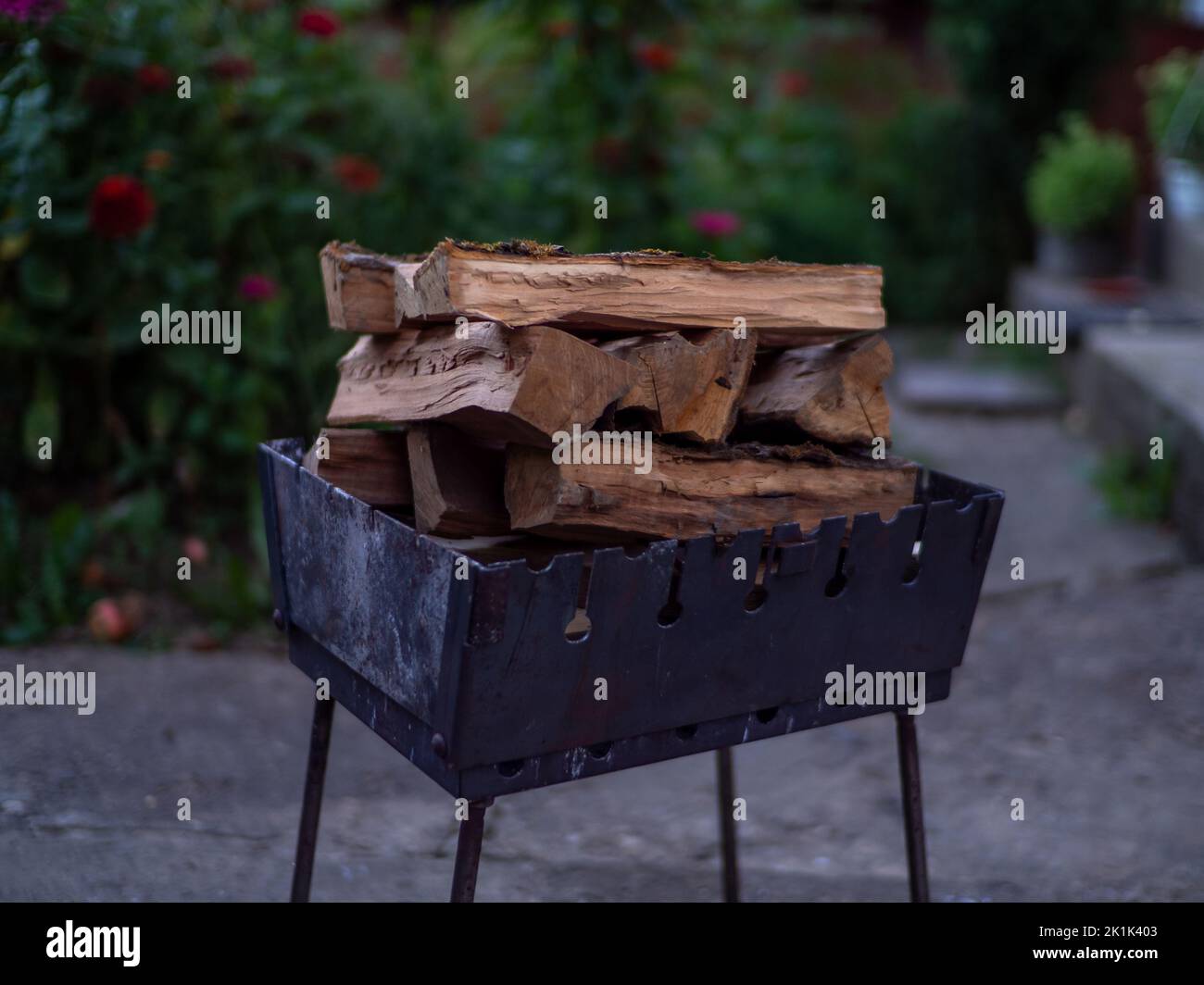 A small folding portable brazier filled with woods Stock Photo - Alamy