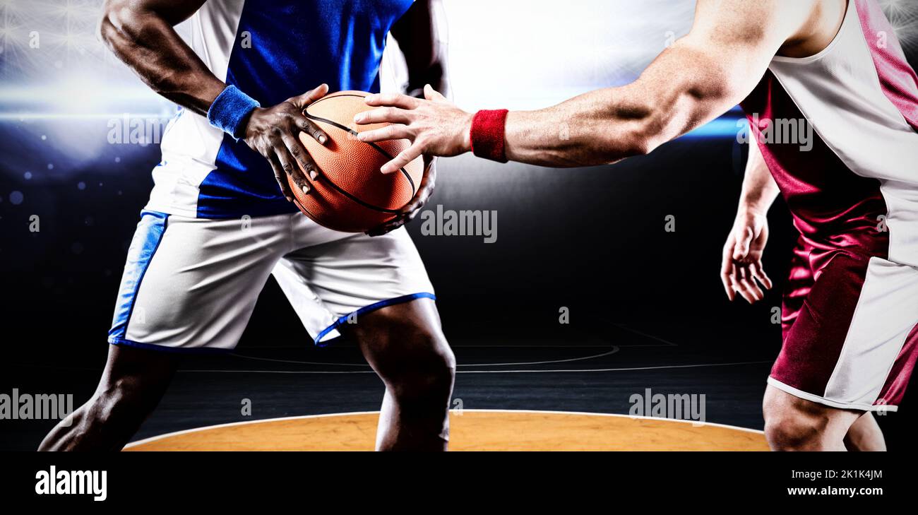 Basketball players in action against basketball court Stock Photo - Alamy