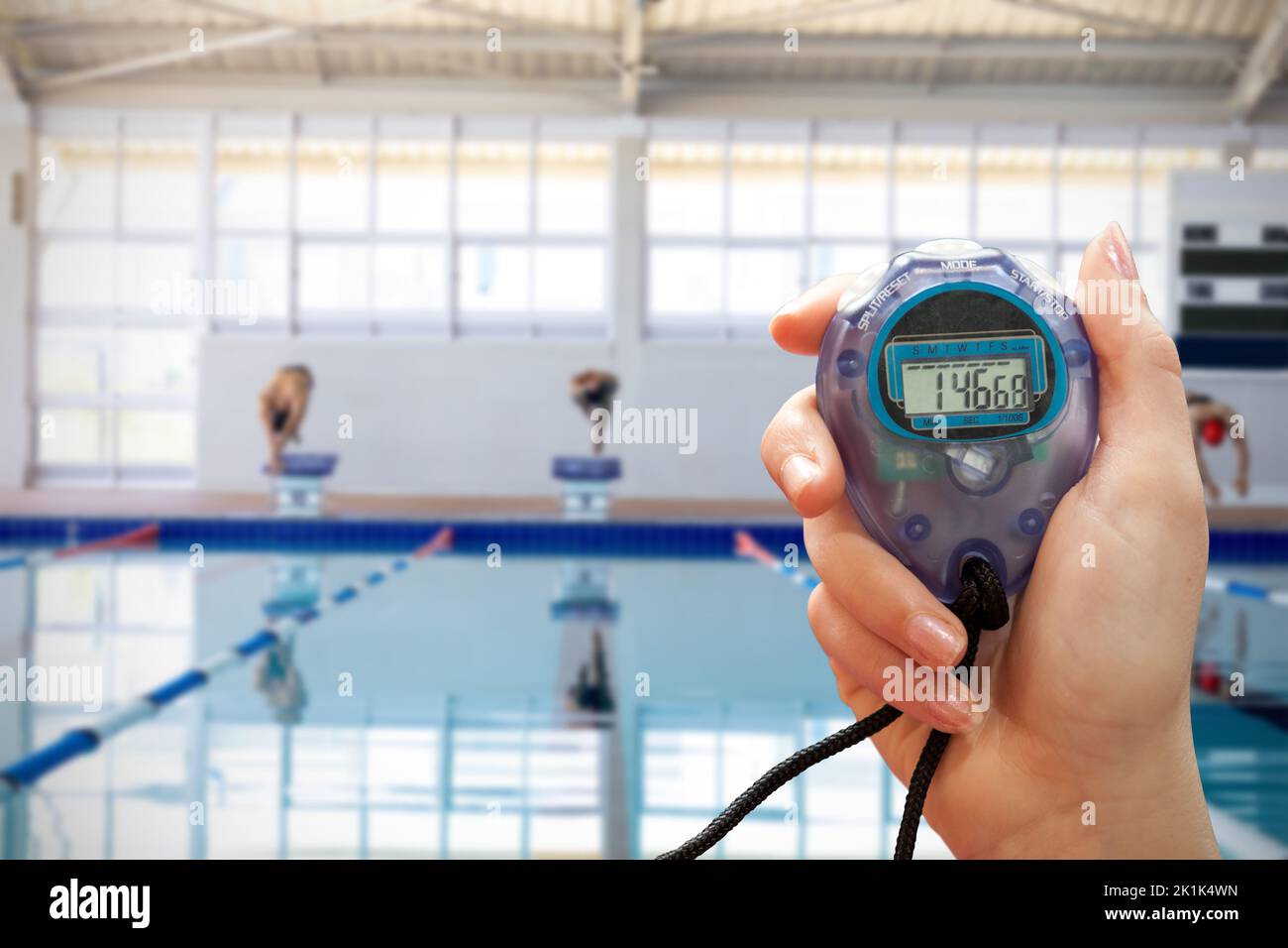 Close up of a hand holding a timer on a white background against ...