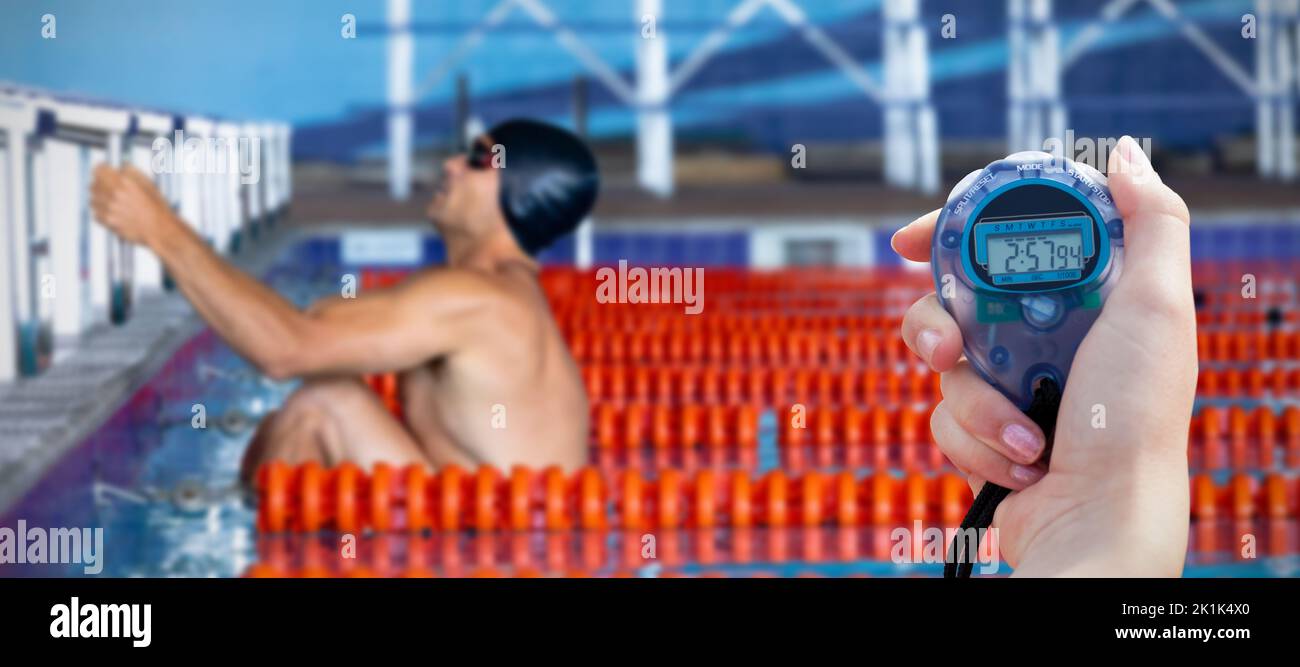 Close-up of a woman holding a chronometer to measure performance ...