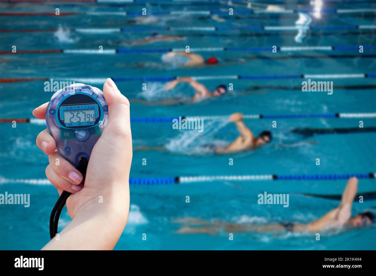 Close-up of a woman holding a chronometer to measure performance ...