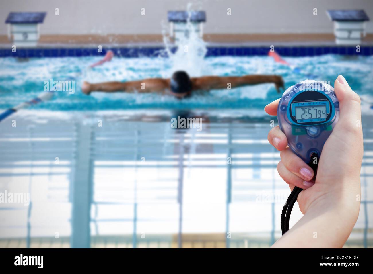 Close-up of a woman holding a chronometer to measure performance ...