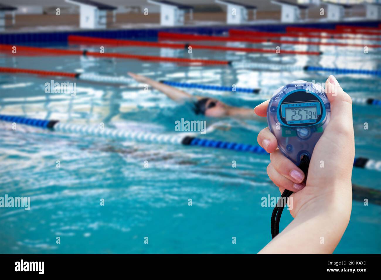 Close-up of a woman holding a chronometer to measure performance ...