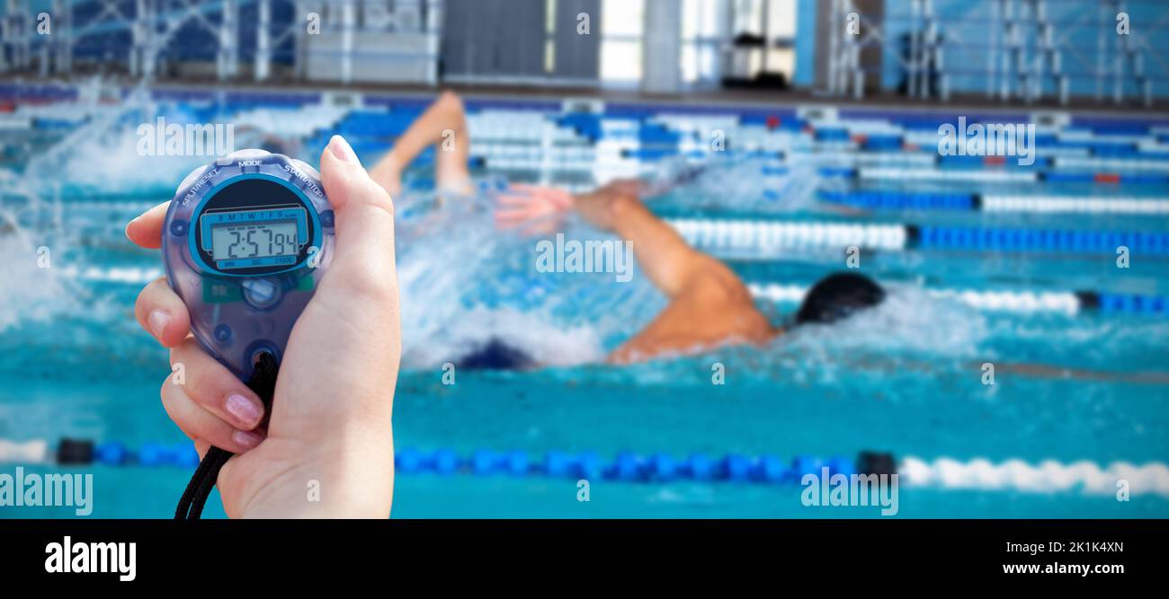 Close-up of a woman holding a chronometer to measure performance ...