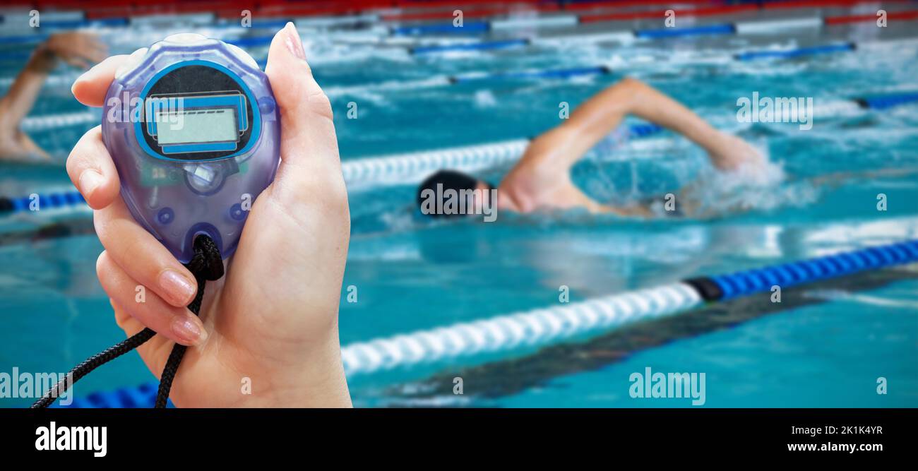 Close up of woman is holding a stopwatch on a white background against ...
