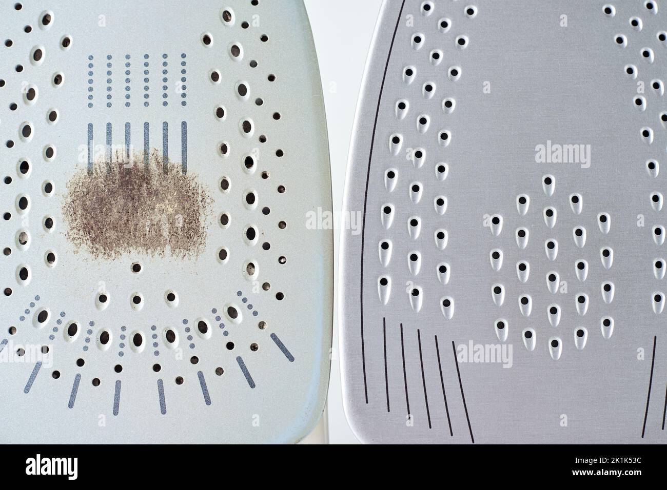Old iron with damaged soleplate and new modern iron on white background ...