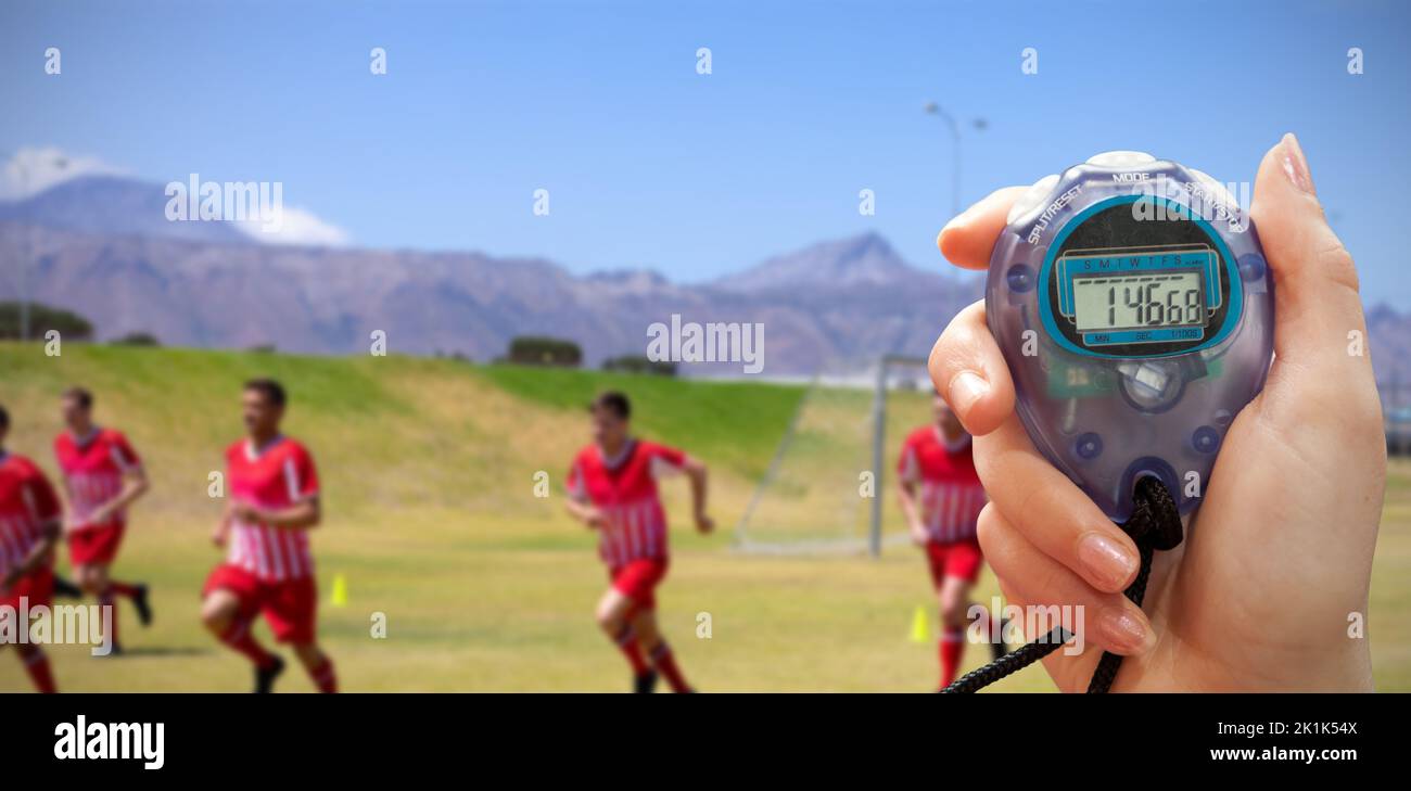 Composite image of close up of a hand holding a timer on a white ...