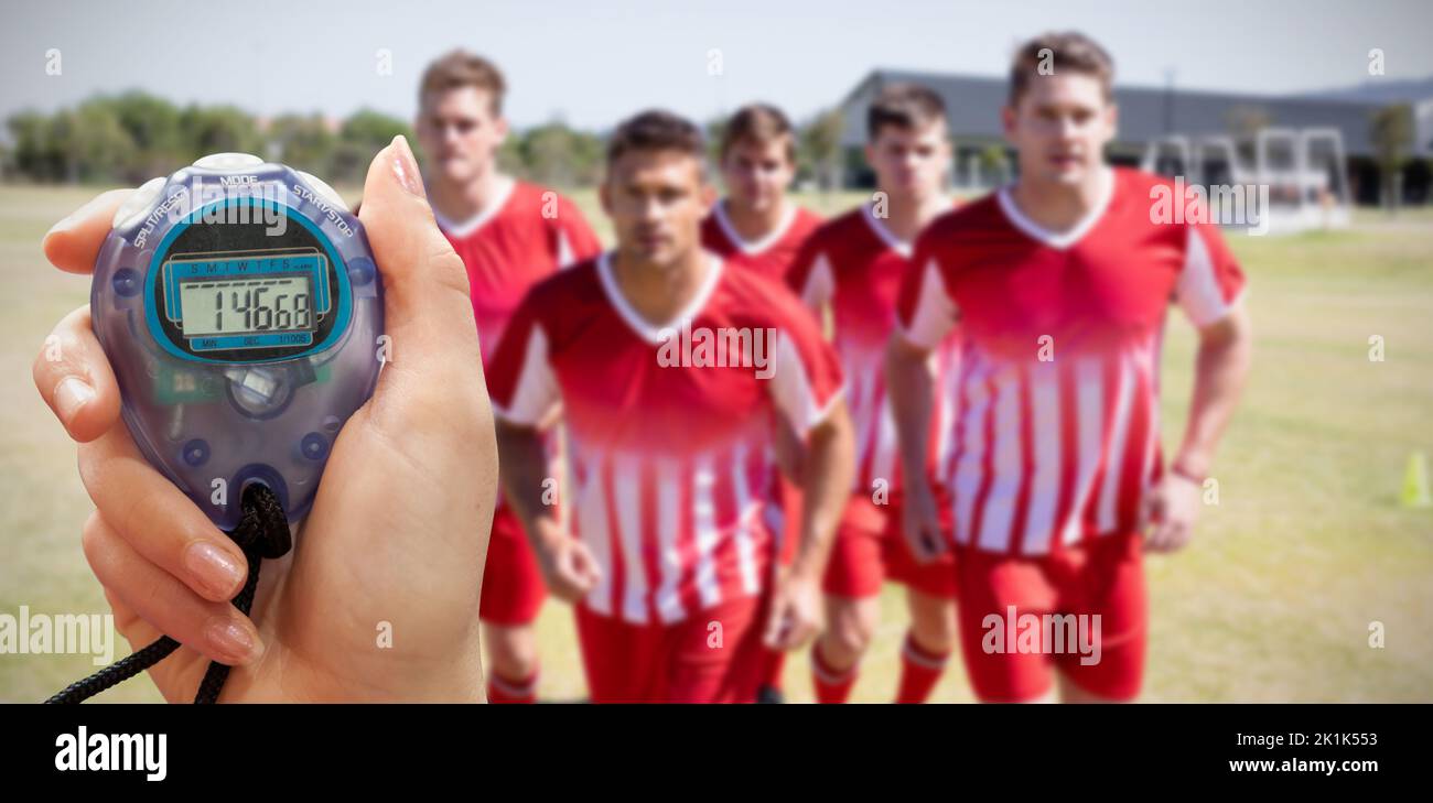 Composite image of close up of a hand holding a timer on a white ...
