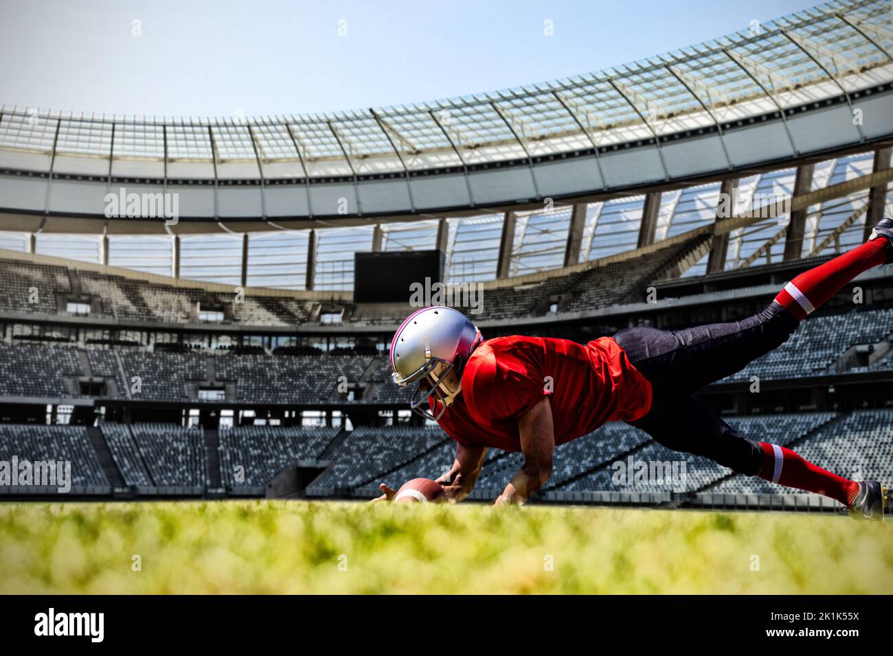American Football Player against rugby goal post on a sunny day in the ...