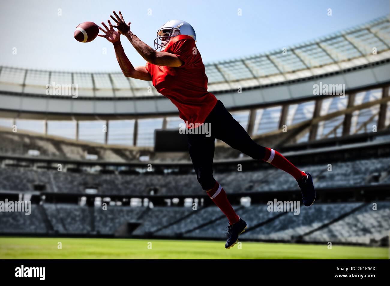 American Football Player against rugby goal post on a sunny day in the ...