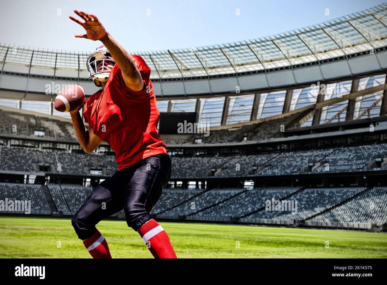 American Football Player against rugby goal post on a sunny day in the ...