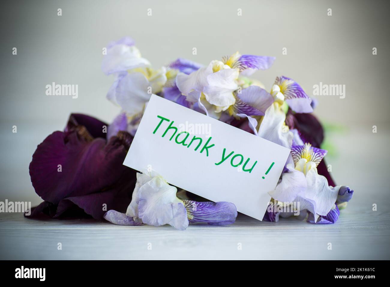 bouquet of beautiful blooming iris flowers on a light wooden background ...