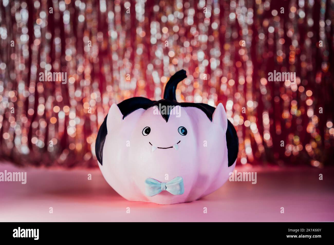 Funny and cute pink Vampire pumpkin with blue butterfly tie and golden ...