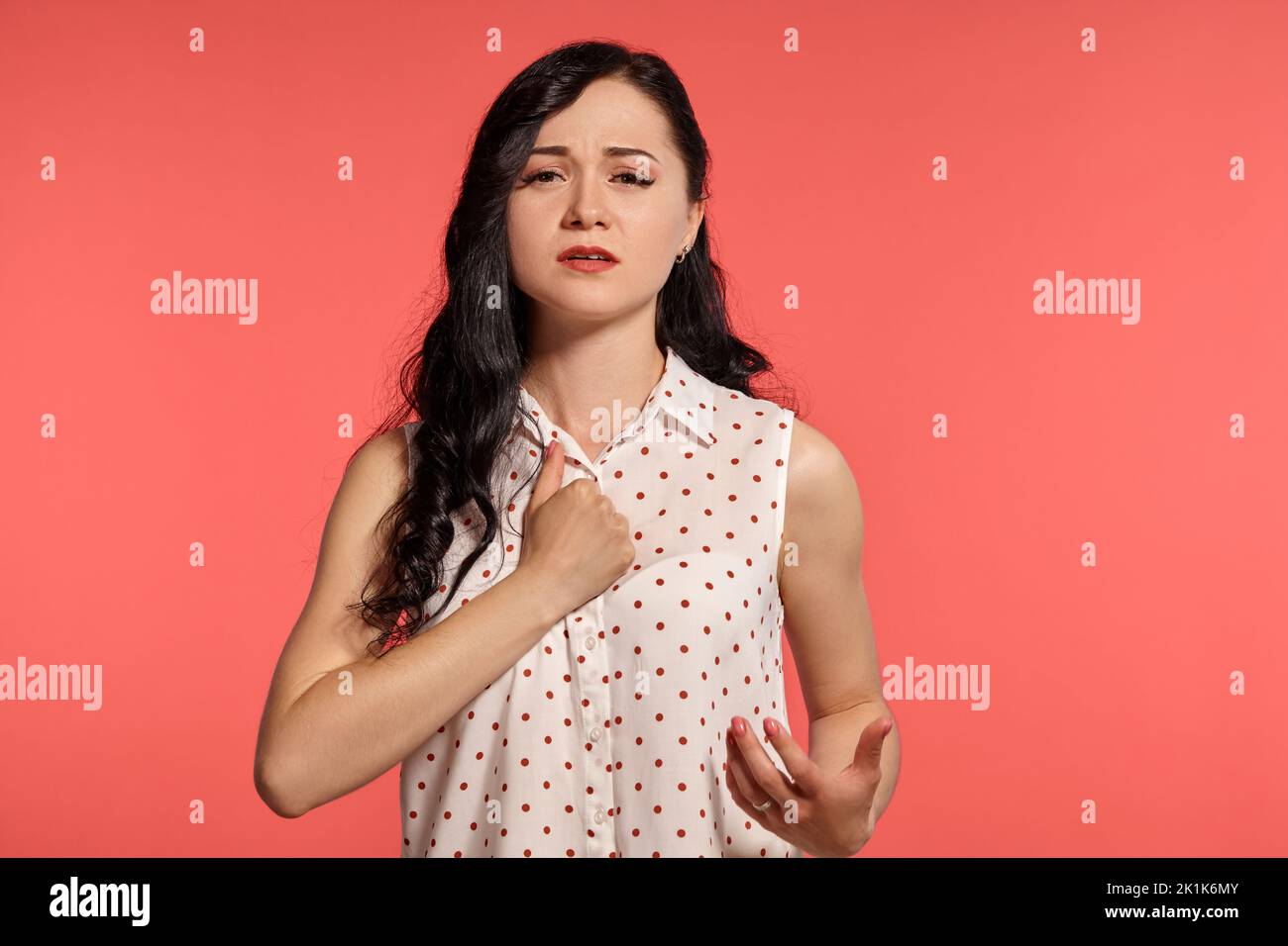 Studio shot of a beautiful girl teenager posing over a pink background ...