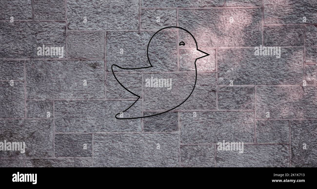 Image of glowing neon bird icon on brick wall. social media and ...