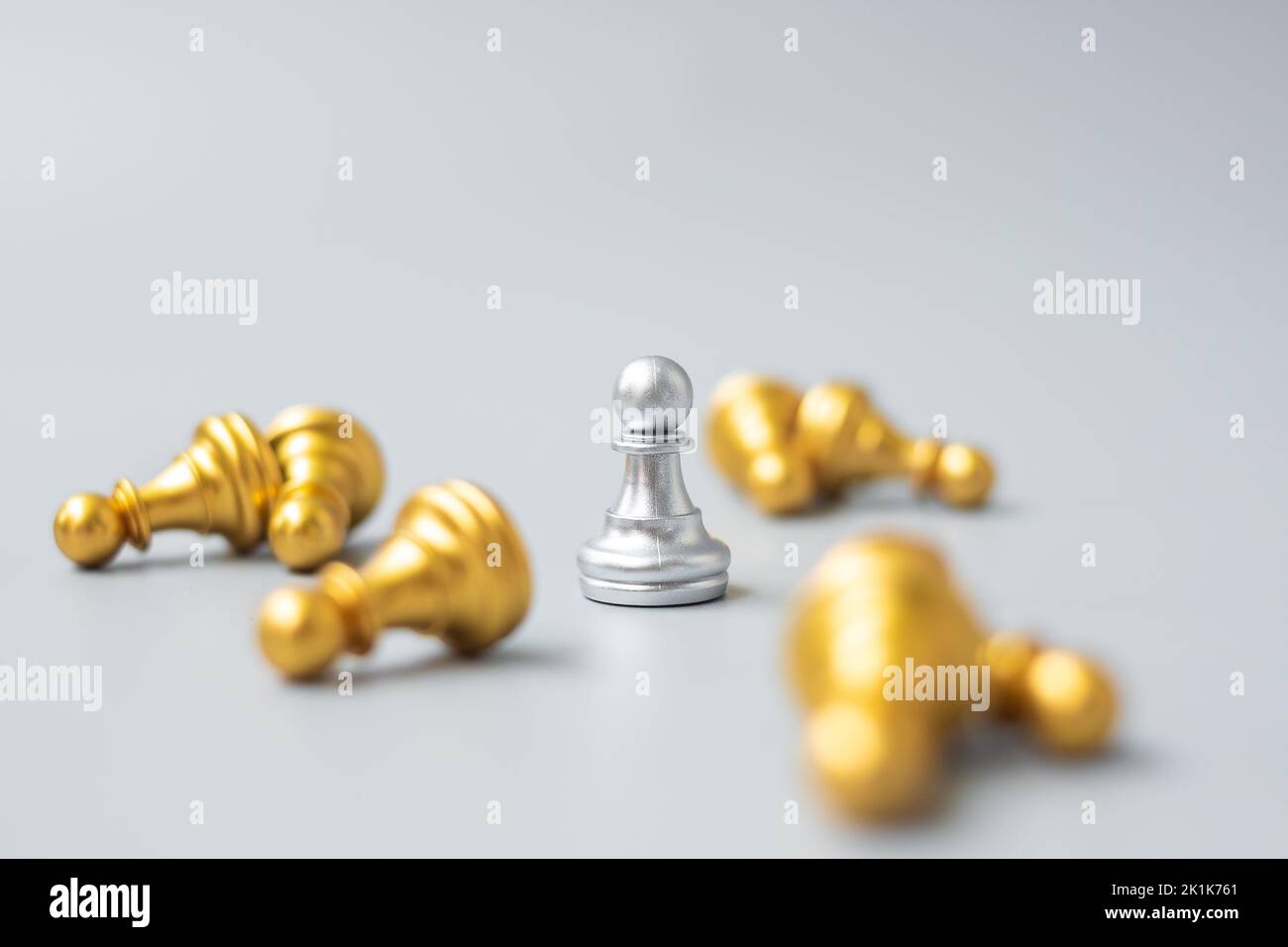 silver Chess pawn figure stand out from crowd of enermy or opponent ...
