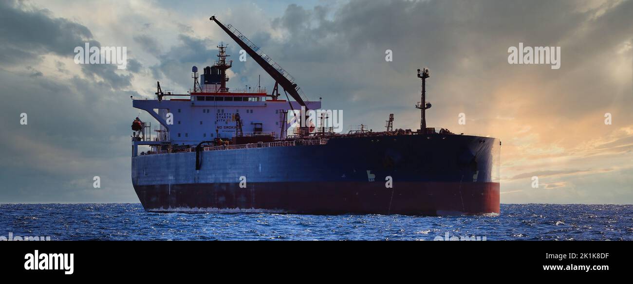 A huge ship preparing for an STS operation in OPL Malta at sunset Stock ...