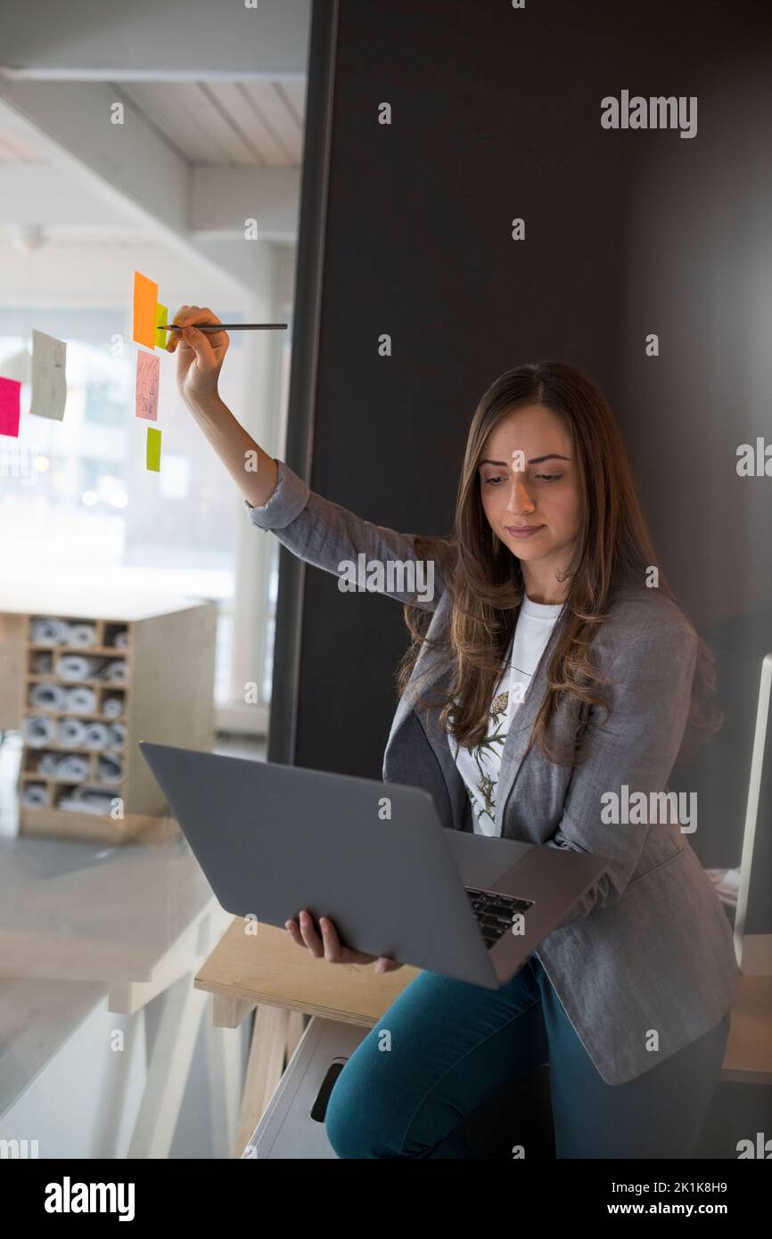 Woman focus on working post it notes hi-res stock photography and ...