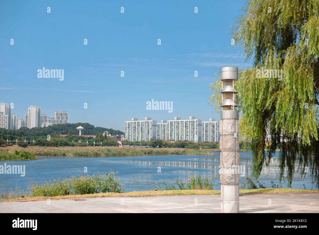 View of lake and apartment buildings at Hwarang Recreation Area park in ...