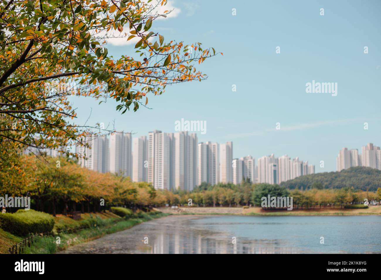 Autumn scenery of lake and apartment buildings at Hwarang Recreation ...