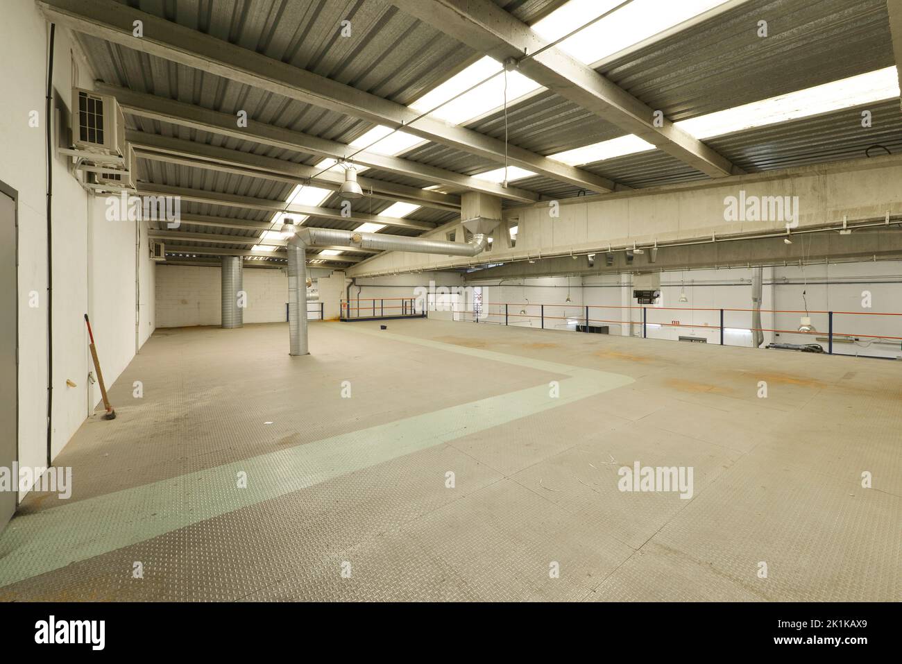 Empty industrial warehouse with large ribbed precast concrete beams and ...