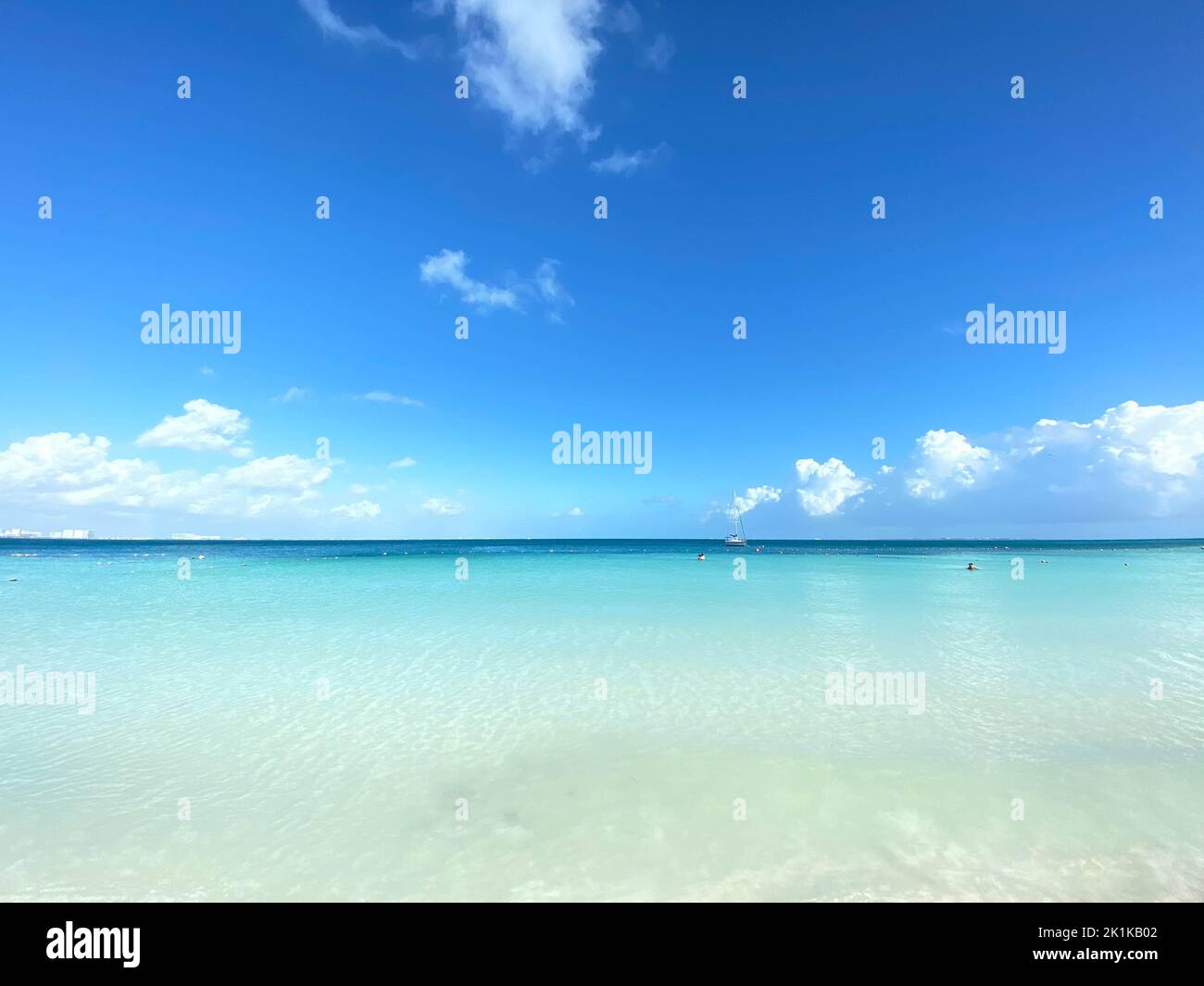 Distant view of people swimming in Gulf of Mexico with yacht in the ...