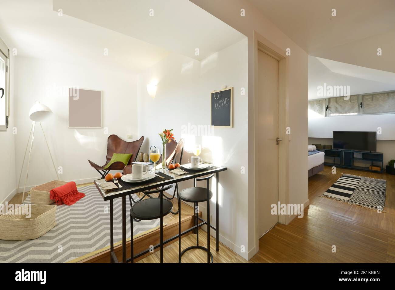 Cozy studio apartment with a living room with a high table with black ...