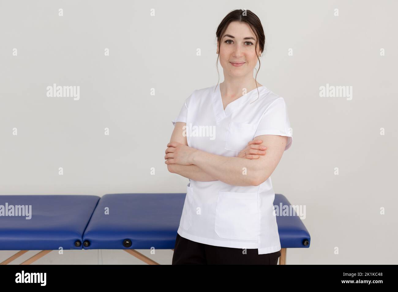 Portrait of young smiling confident masseuse therapist doctor woman wearing white uniform ...