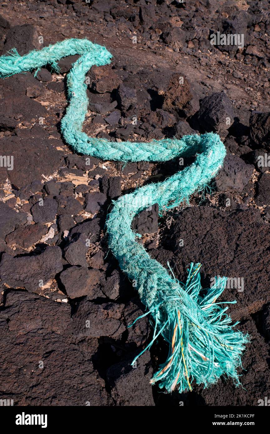 Old plastic rope with frayed ends and deteriorated fibers coming out ...