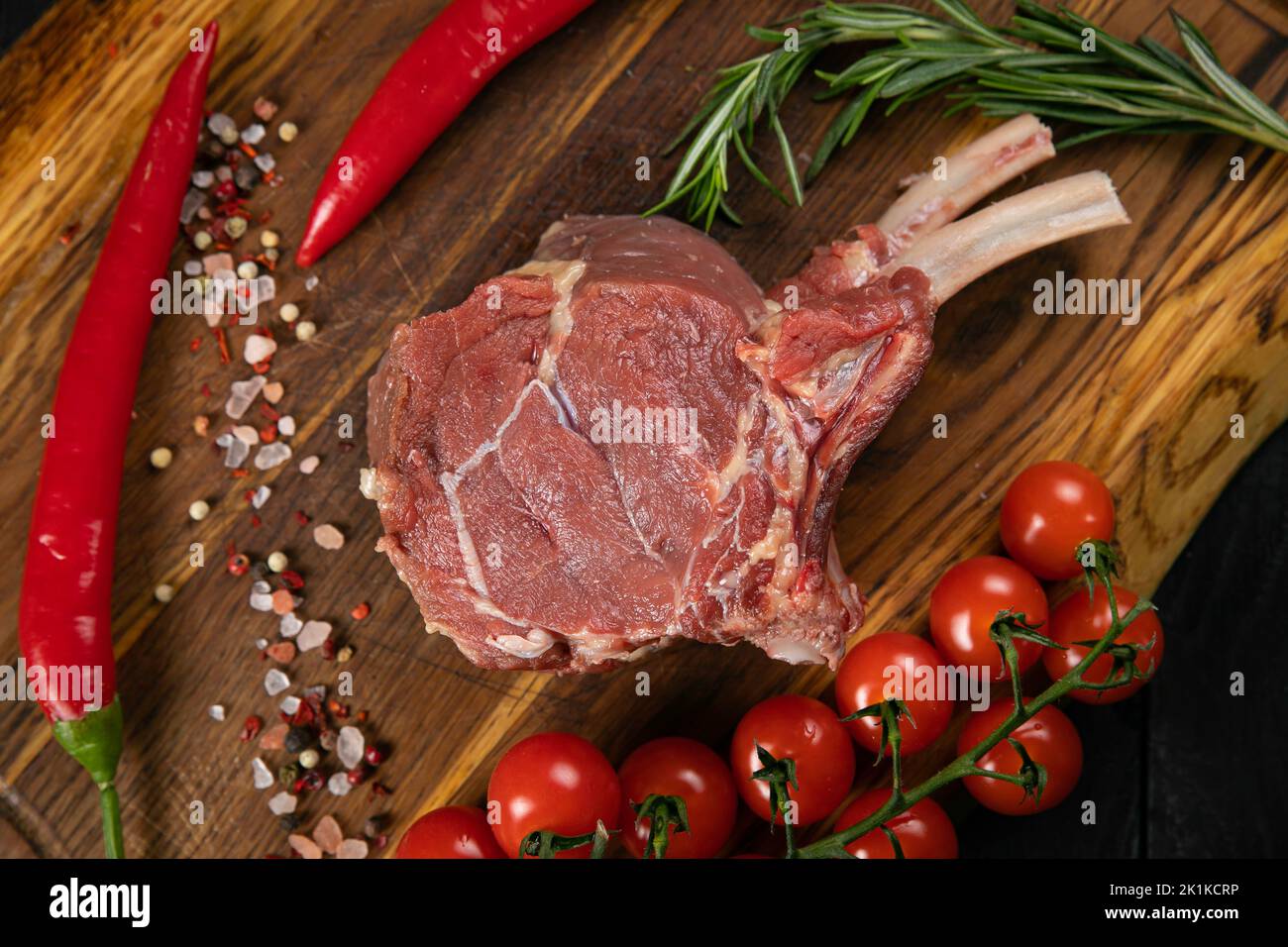 A raw seasoned beef steak on a wooden board Stock Photo - Alamy
