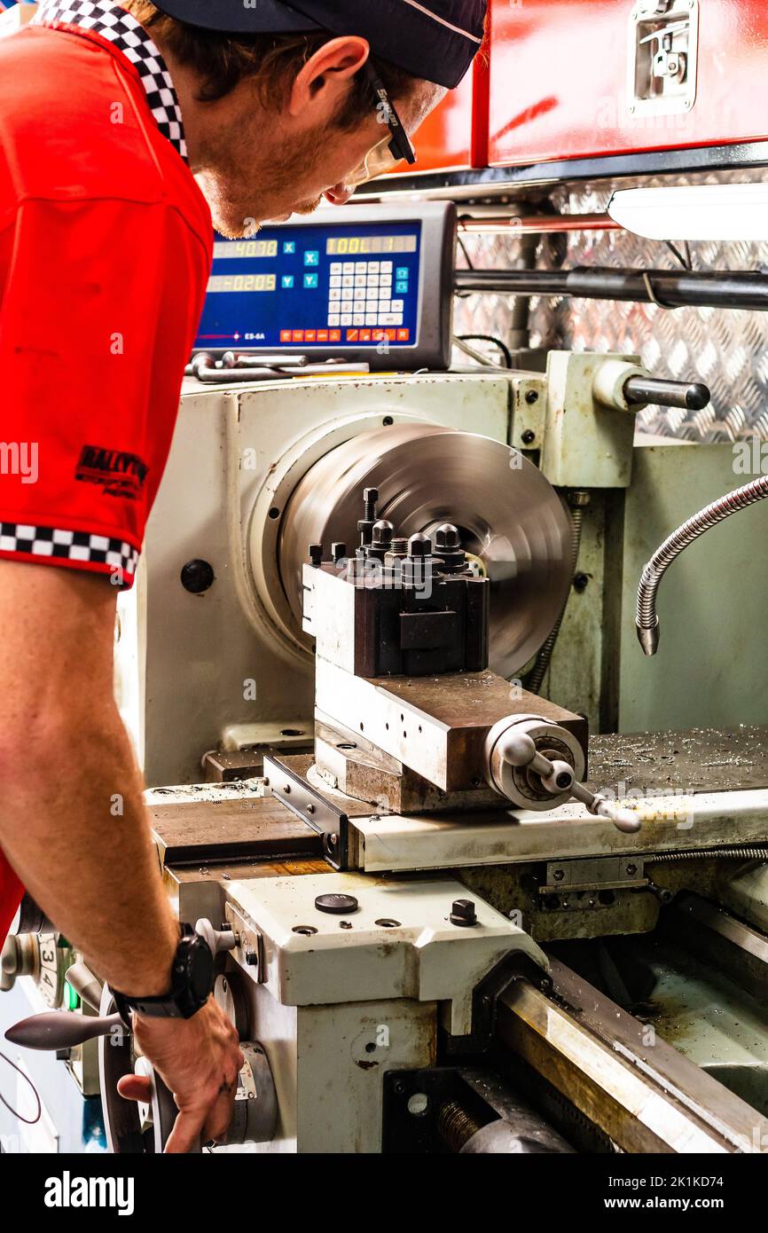 A portrait of a full force racing component operating a lathe Stock ...
