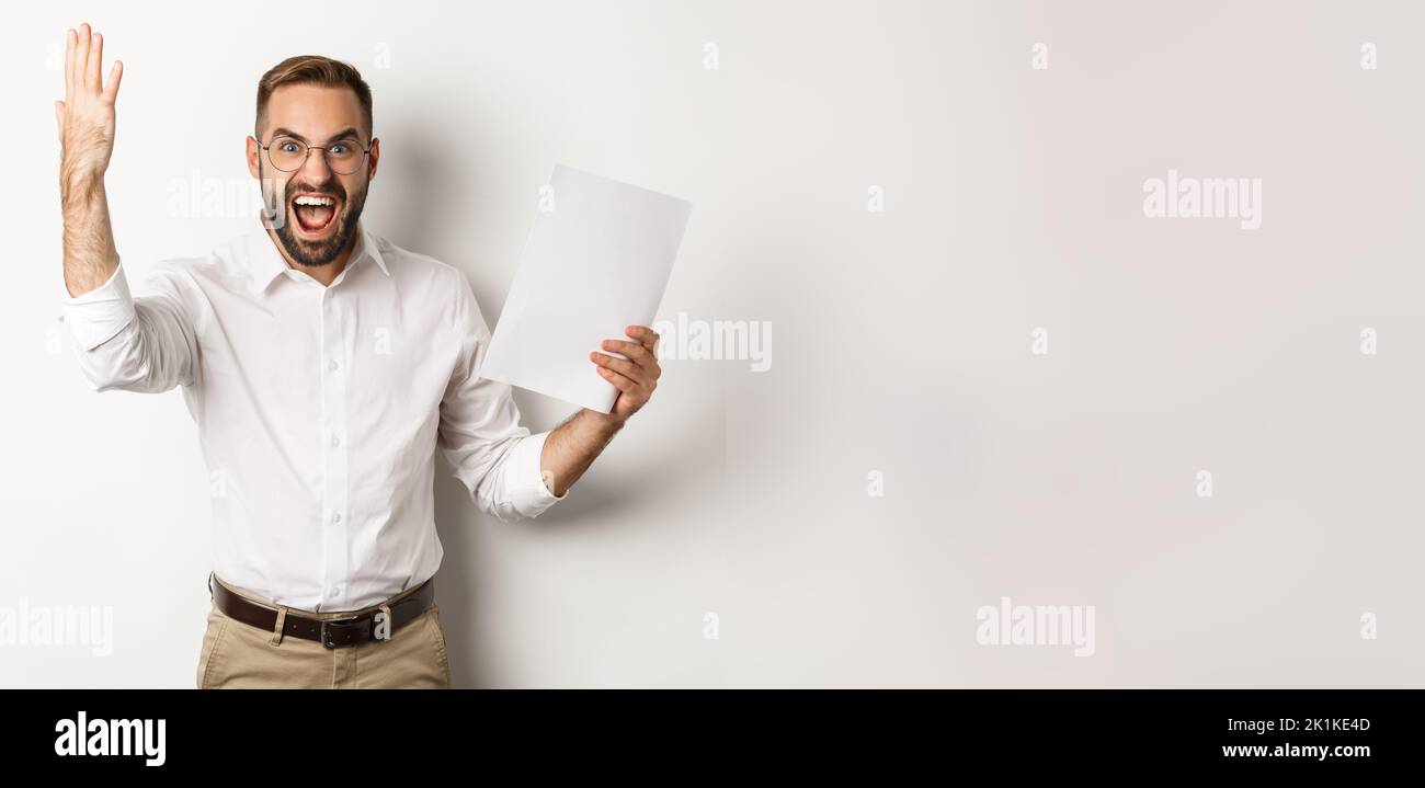 Angry businessman shouting and showing bad report, looking disappointed ...
