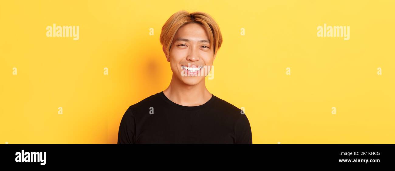 Close-up of handsome stylish asian guy with fair hair, smiling happy ...
