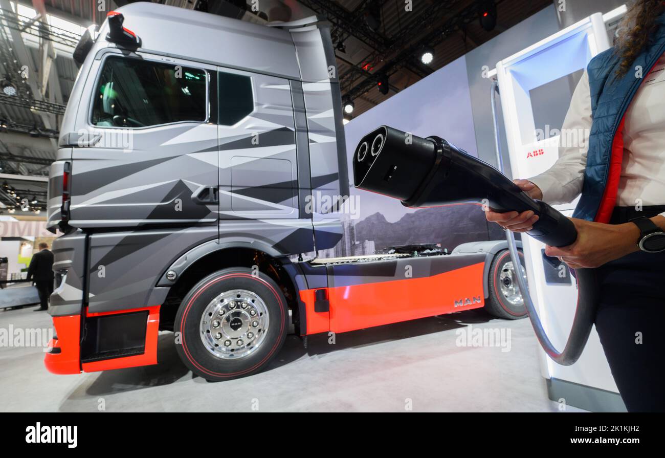 Hanover, Germany. 19th Sep, 2022. A MAN employee holds a plug of the ...