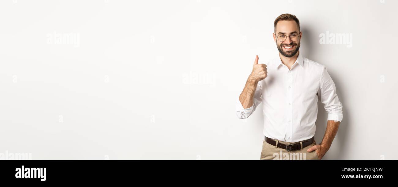 Satisfied successful boss showing thumb up, approve and praise good ...