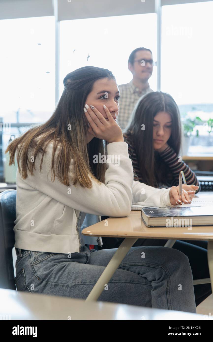 Focused high school girl student listening in classroom Stock Photo - Alamy