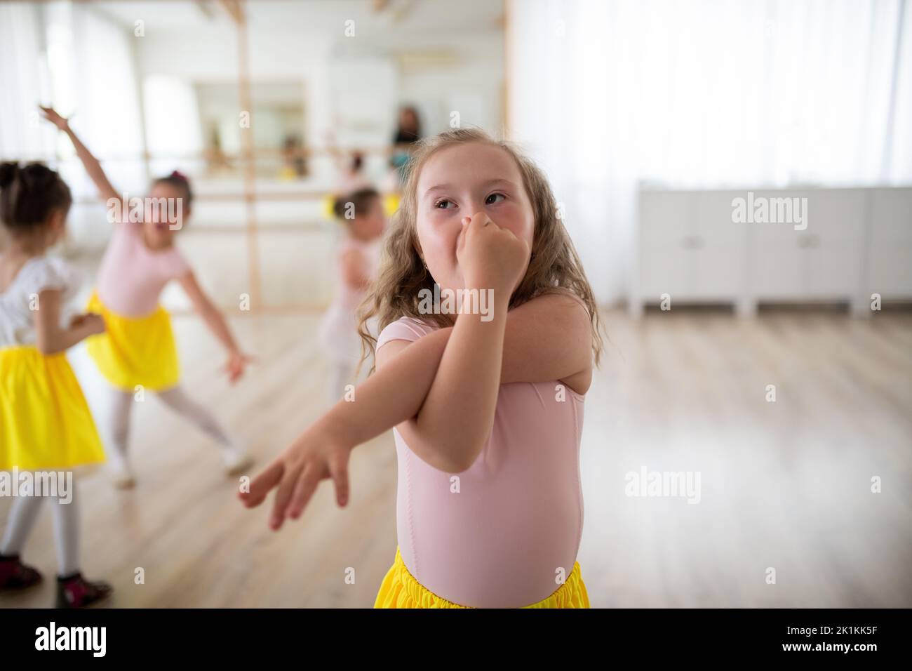 Little girl with down syndrome imitating elephant, having fun during ...