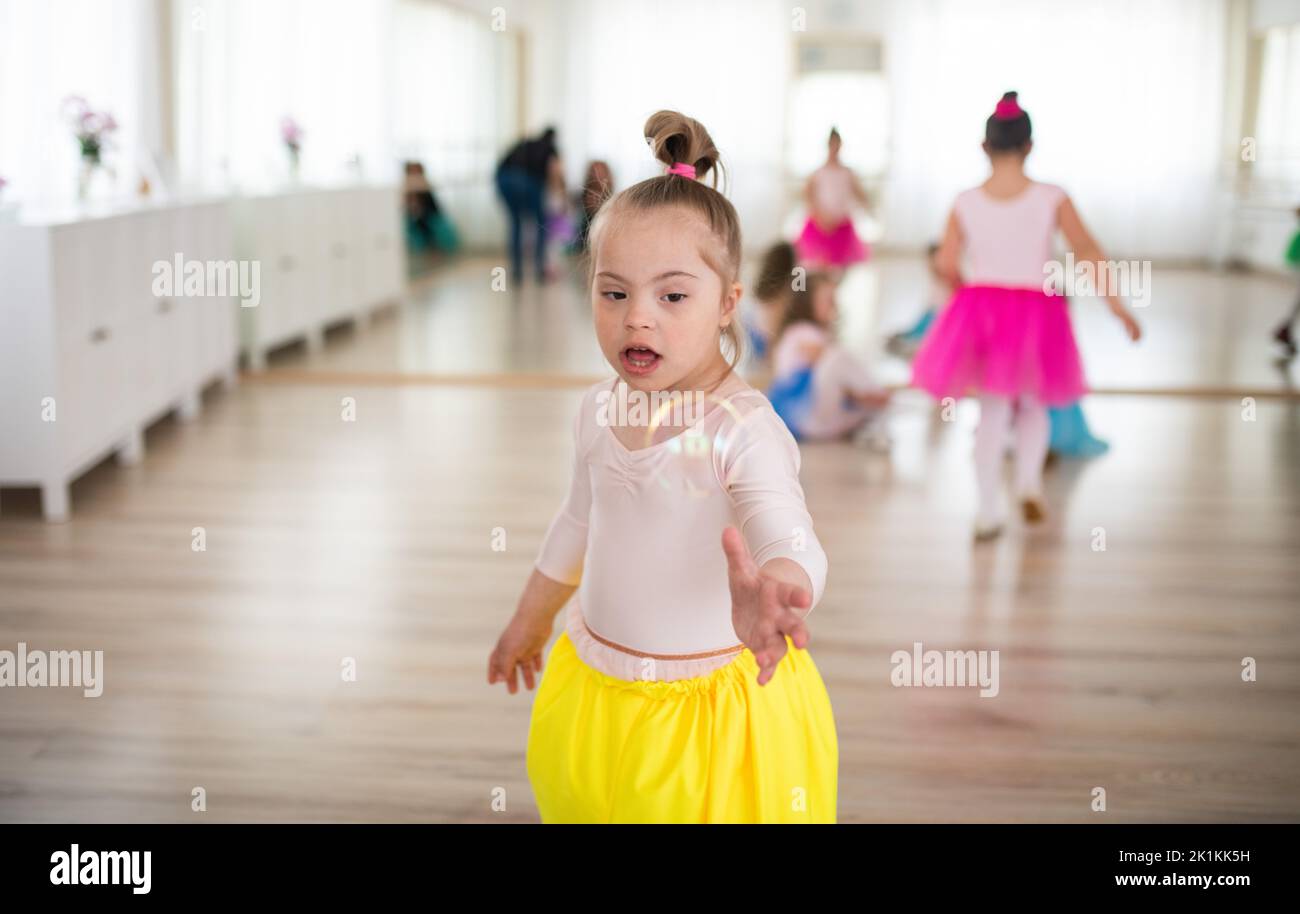Little girl with down syndrome at ballet class in dance studio. Concept ...