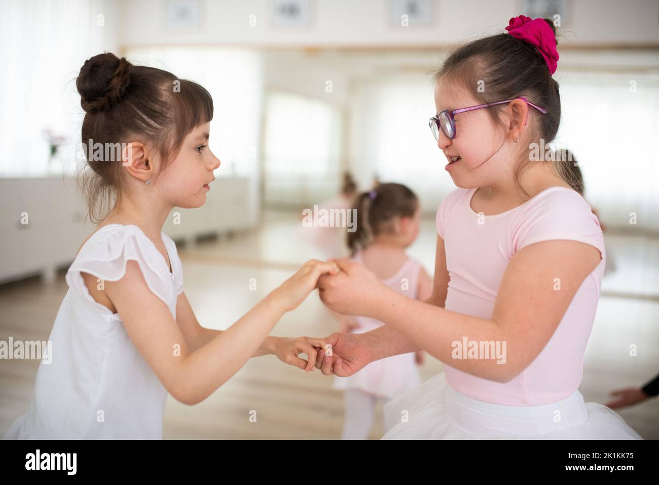 Little disabled girls dancing together in ballet school studio. Concept ...