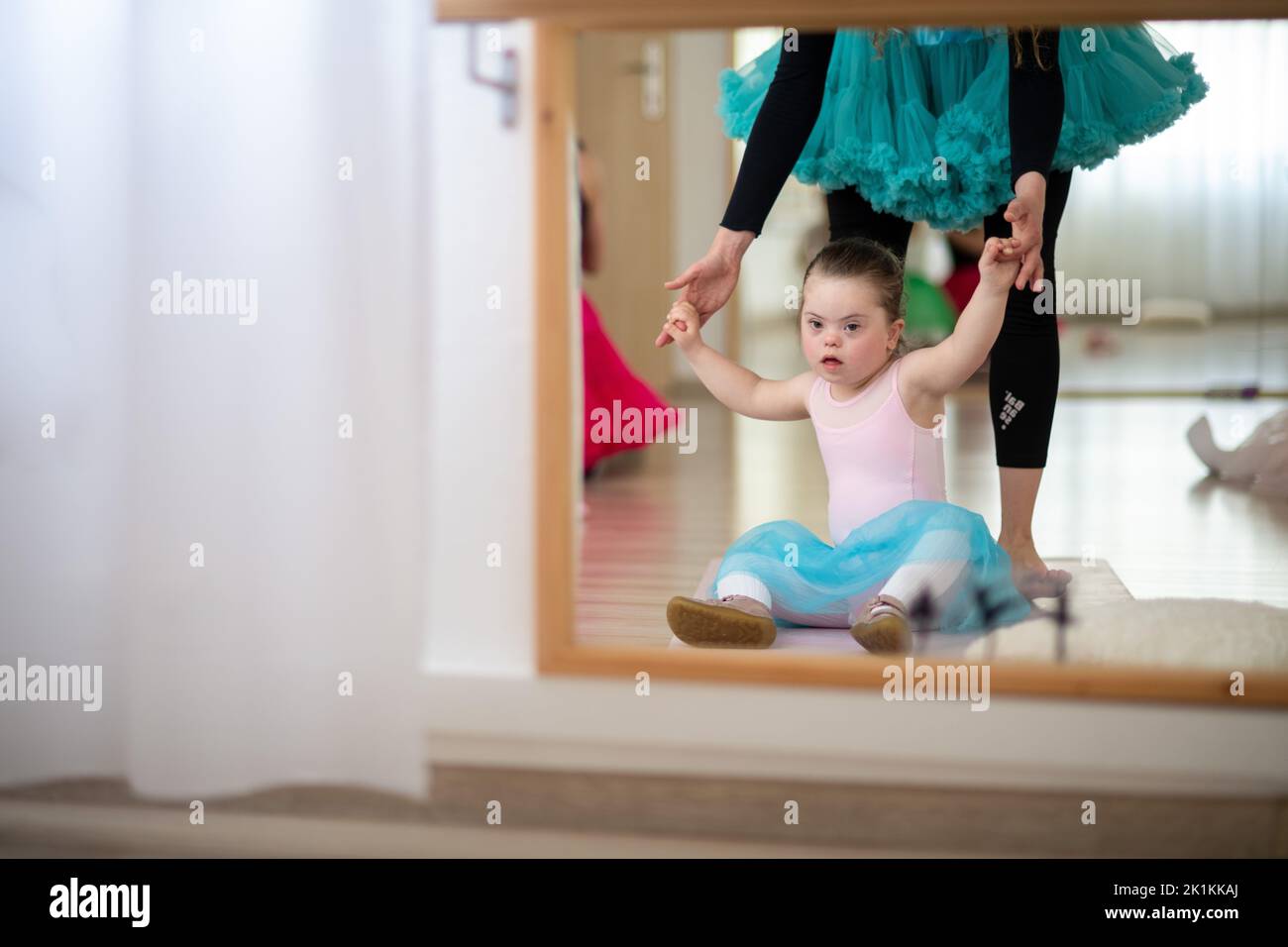 Little girl with down syndrome learning ballet with dance lecteur in ...