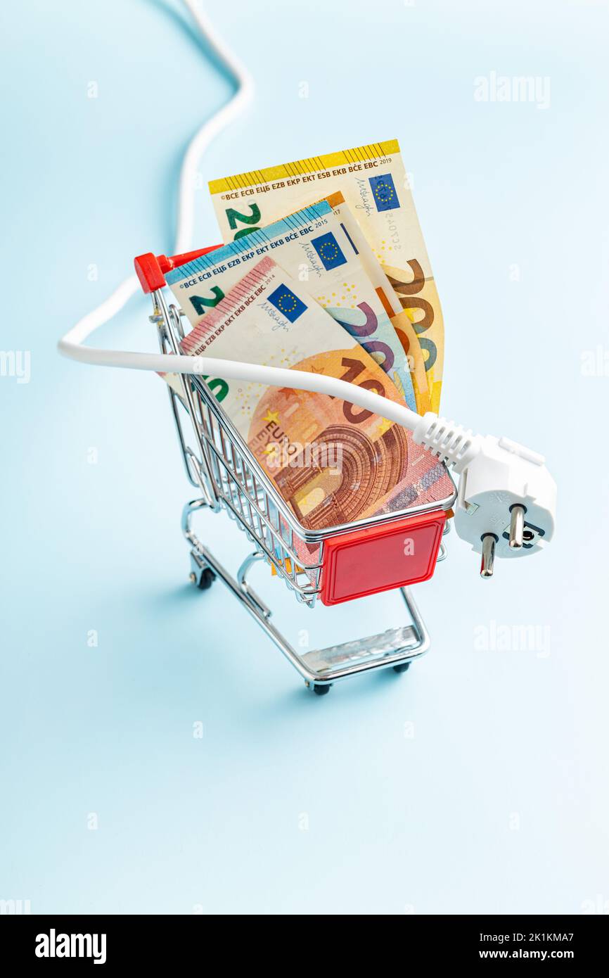 Electric plug and euro money in the shopping cart. Concept of ...