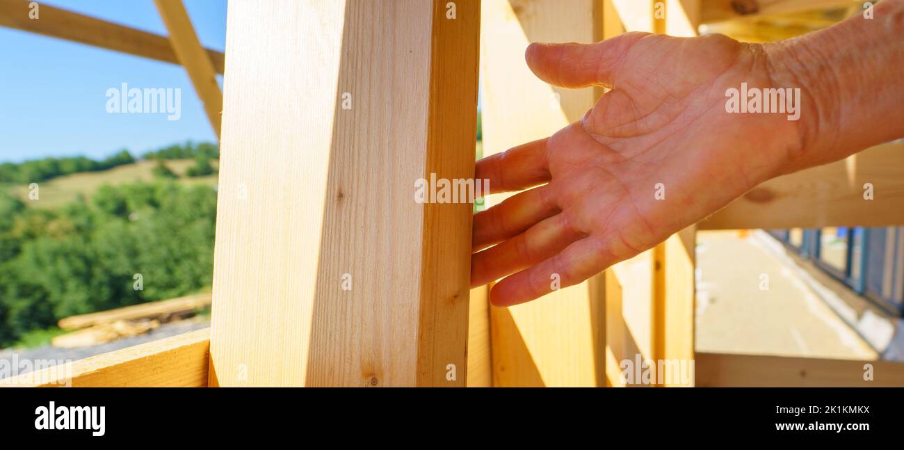 Close-up of woman hand touching wooden eco house framing. Concept of ...