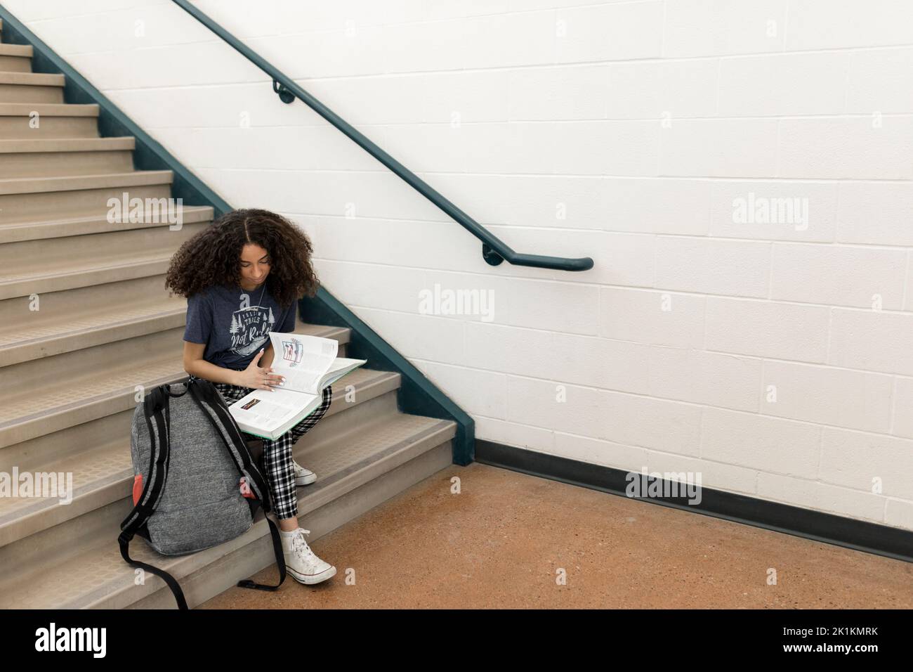 Reading book on steps hi-res stock photography and images - Alamy