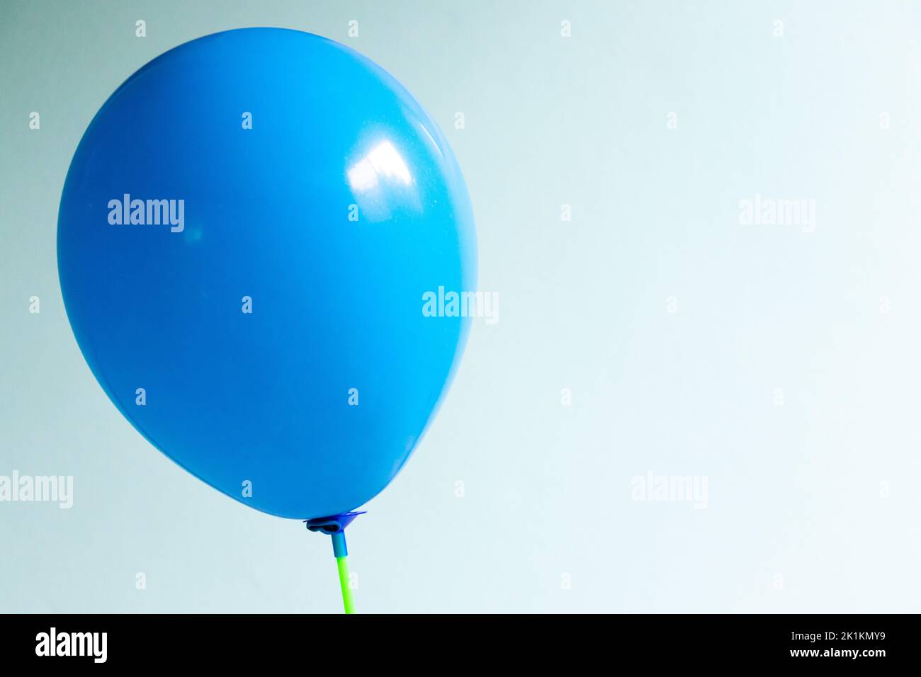 Blue balloon on blue concrete wall background with copy space Stock ...
