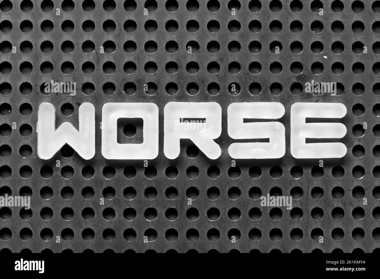 White alphabet letter in word worse on black pegboard background Stock ...