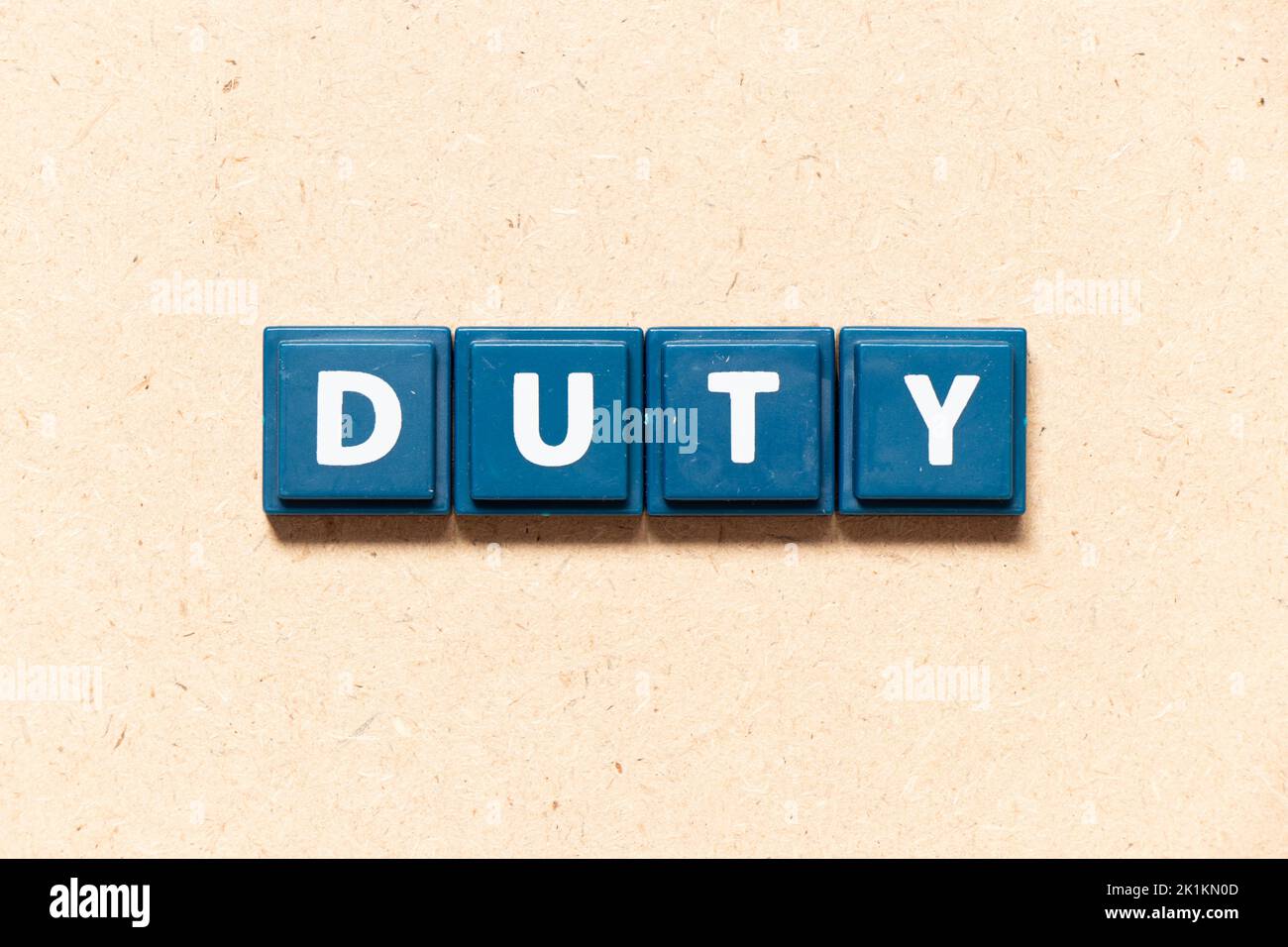 Tile letter in english word duty on wood background Stock Photo - Alamy