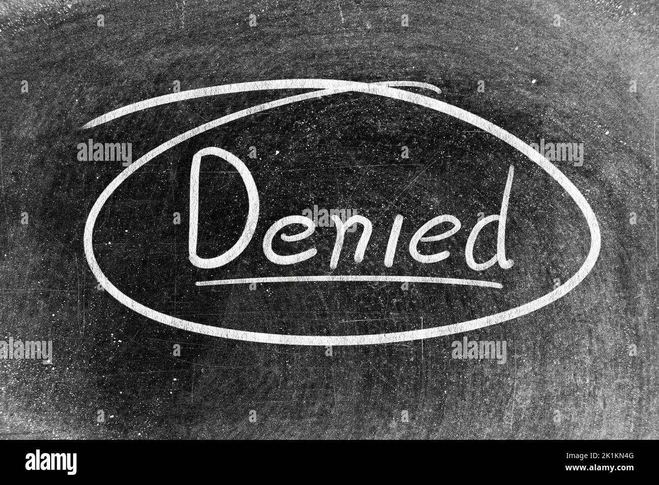 White chalk hand writing in word denied on blackboard background Stock ...