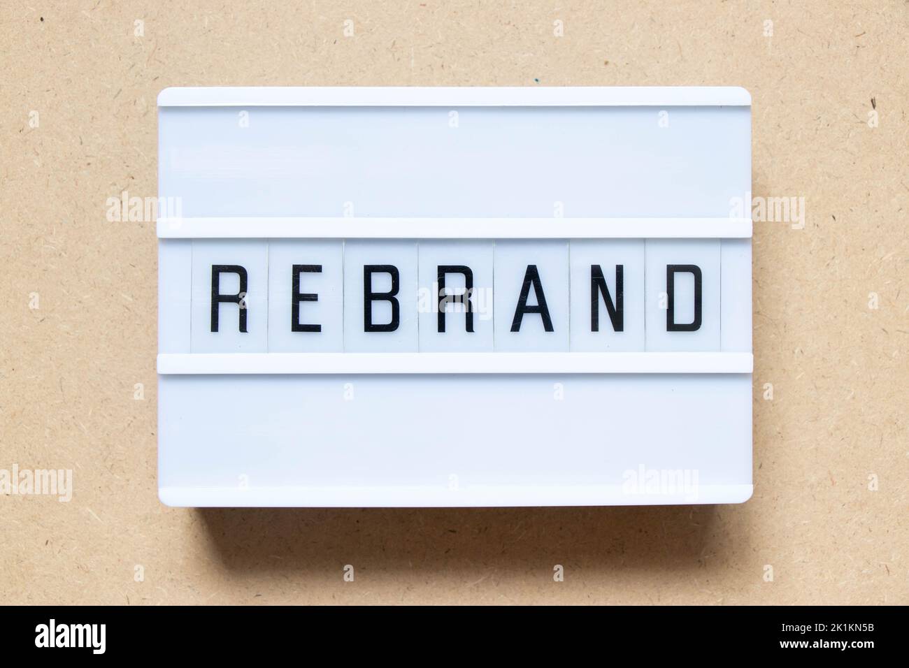 Lightbox with word rebrand on wood background Stock Photo - Alamy